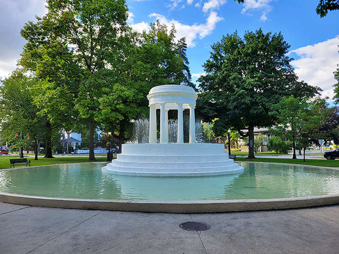 Brooks Memorial Fountain transforms from daytime classical beauty to evening light show—Marshall's crown jewel in water form.