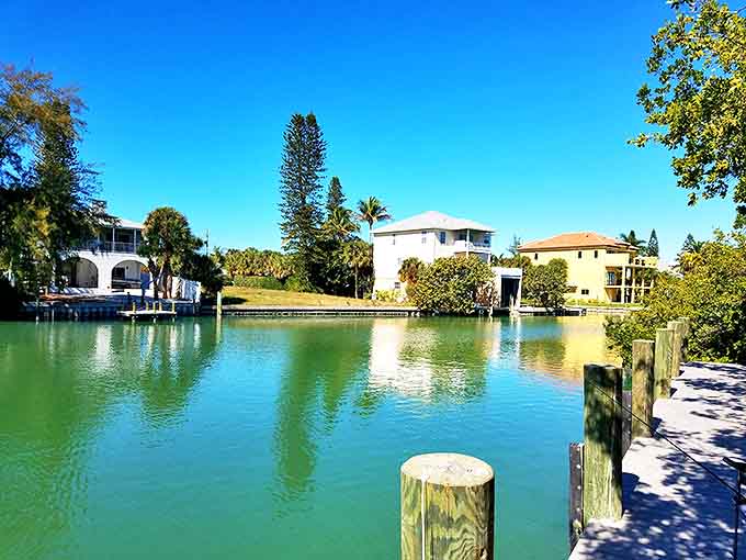 Waterfront homes reflect in mirror-like canals, where Florida living reaches its most serene expression.