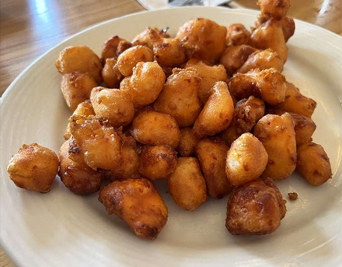 Wisconsin cheese curds transformed into golden pillows of joy &ndash; crunchy outside, stretchy-melty inside, and utterly impossible to stop eating.