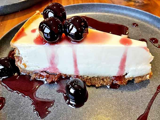 Cheesecake dreams come true with this silky slice topped with plump cherries in a glossy sauce that balances sweet and tart perfectly.