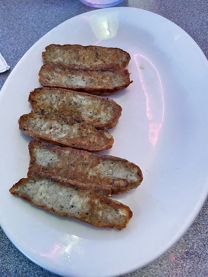 Chicken sausage links, perfectly browned and ready to complete your breakfast symphony &ndash; simple food executed with surprising attention to detail.