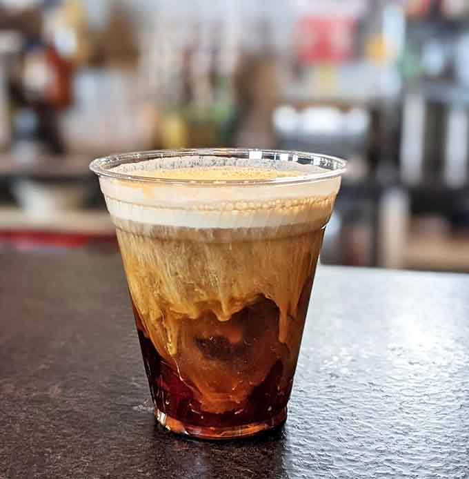 This layered coffee creation isn't just a beverage &ndash; it's liquid architecture with distinct strata of caffeinated bliss.