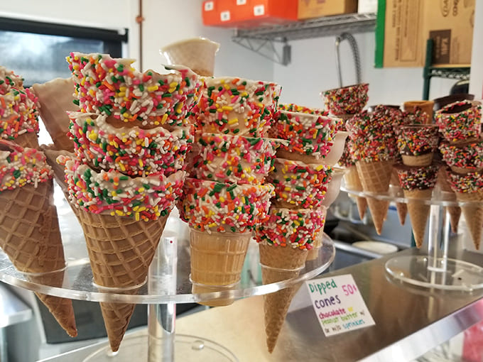 Sprinkle-dipped waffle cones standing at attention like delicious soldiers, ready for their ice cream crowns.