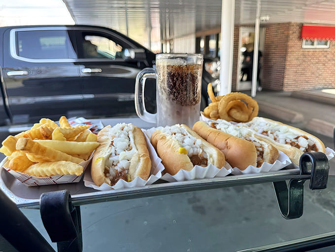 A feast fit for champions – loaded coney dogs, golden onion rings, and ice-cold root beer create the holy trinity of drive-in dining excellence.