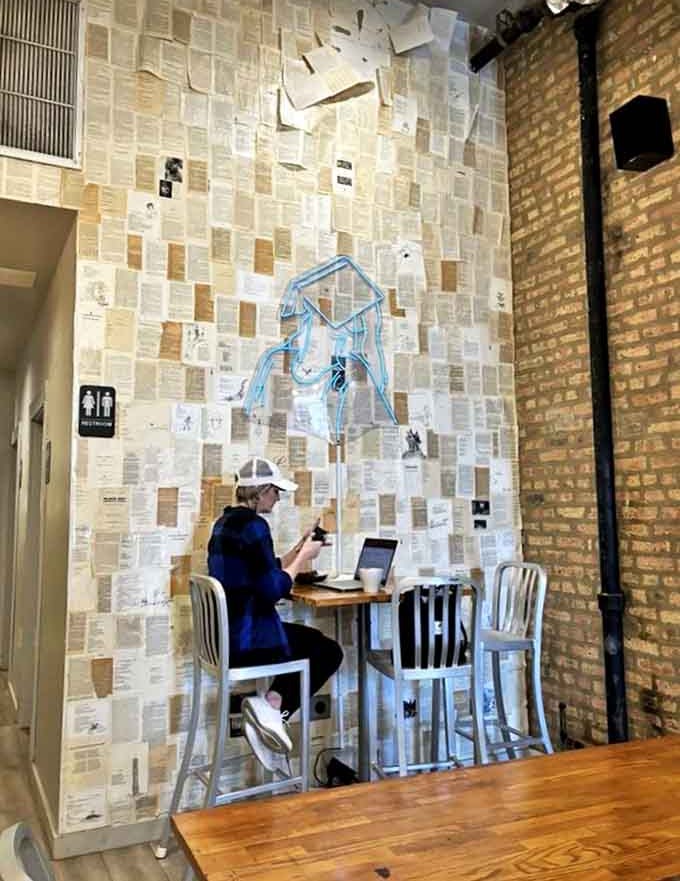 That wall of book pages creates the most Instagram-worthy reading nook in Chicago, complete with ethereal blue neon lighting.