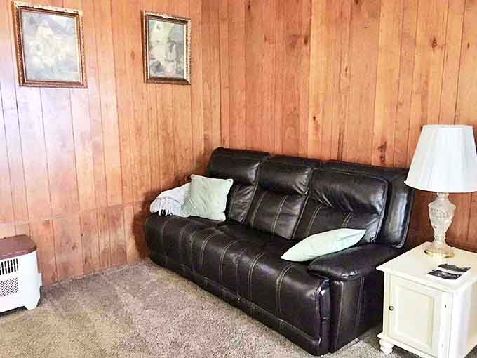 This leather sofa against wood-paneled walls creates the perfect spot for afternoon naps or late-night conversations about life's big questions.