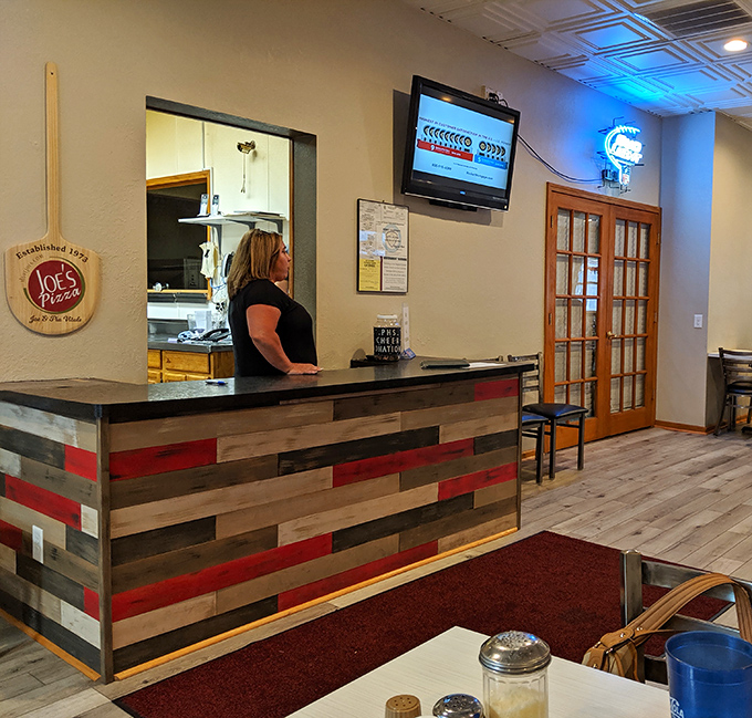 Behind the counter, where pizza dreams become reality &ndash; the heart of Joe's operation in plain view.