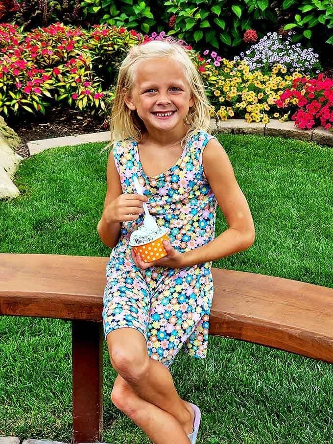 A sweet ice cream moment in a colorful garden setting creates memories that linger long after the last bite.