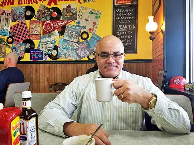 Coffee and conversation flow freely against a backdrop of vinyl records and pop culture nostalgia.