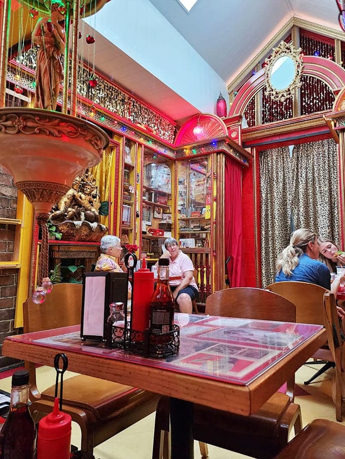 Patrons enjoy the intimate atmosphere, where strangers become friends united by their appreciation for tubular meat and theatrical dining.