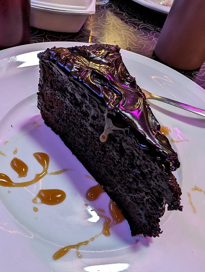 A monument to chocolate excess &ndash; moist, dark cake topped with glossy ganache and caramel drizzles that make sharing a moral dilemma.