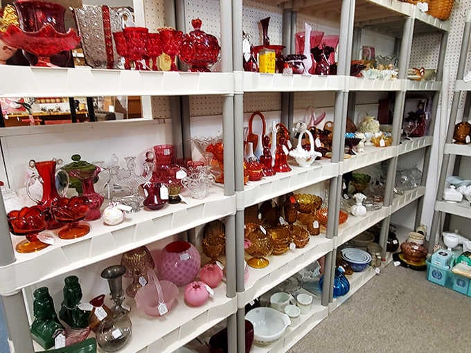 Ruby red glassware creates a stunning visual display, each piece glowing like a jewel under the mall's lighting.