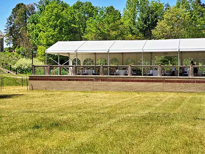 White canvas pavilion promises celebration against verdant backdrop. Even empty, it hums with anticipation of laughter, toasts, and memories waiting to be made.