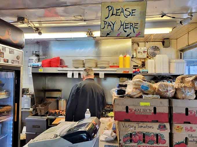 The kitchen's handwritten "PLEASE PAY HERE" sign has directed hungry patrons for generations &ndash; simple instructions in a complicated world. Photo credit: <a href="https://www.yelp.com/user_details?userid=11aM2nkWZxGcUhoK9mGXdw" target="_blank" rel="noopener noreferrer">Paul S.</a>	The kitchen's handwritten "PLEASE PAY HERE" sign has directed hungry patrons for generations &ndash; simple instructions in a complicated world.