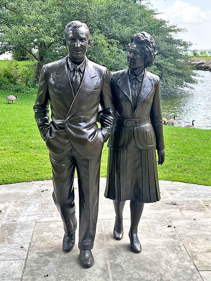 Eternally arm-in-arm, Edsel and Eleanor's bronze likenesses gaze over the lake they loved, capturing a moment of quiet companionship.