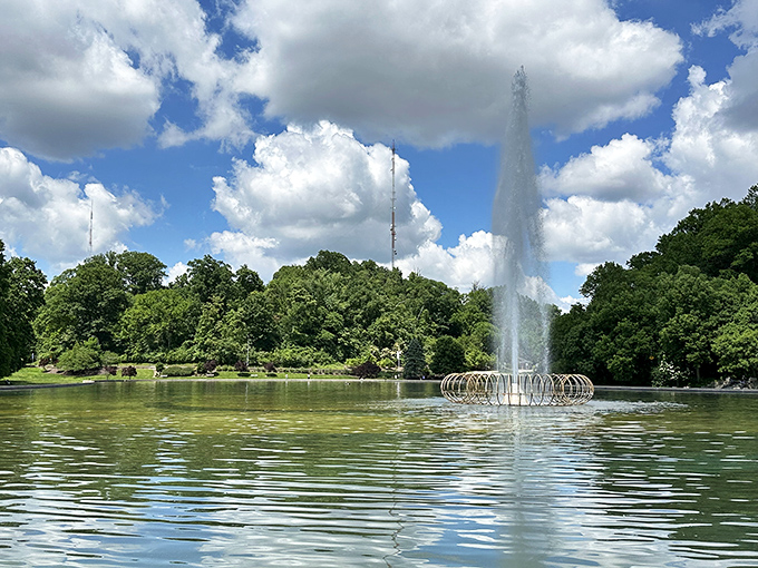 The fountain's dancing waters catch sunlight and sky, creating ephemeral art that changes with each passing moment.