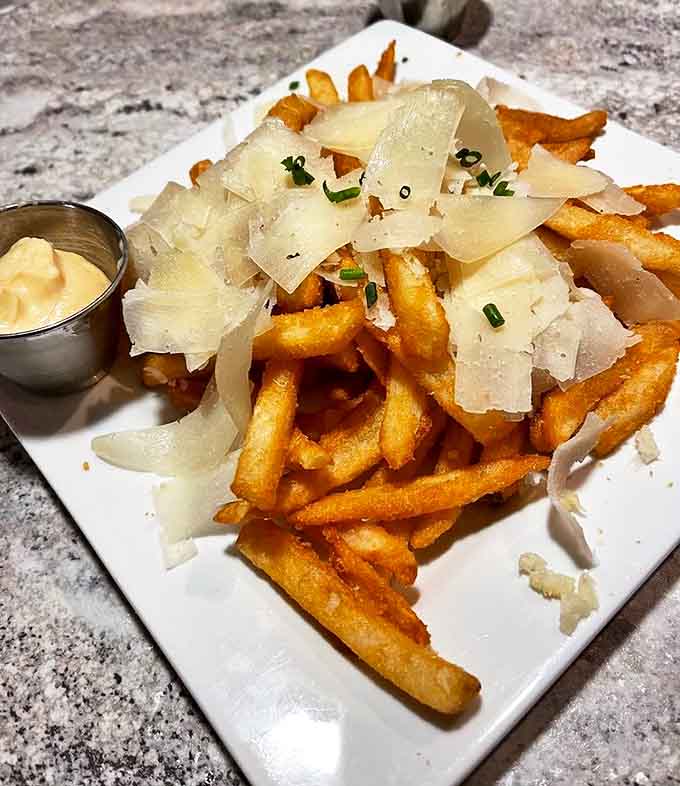Truffle fries topped with shaved parmesan transform the humble potato into something worth fighting over &ndash; sharing optional but not recommended.