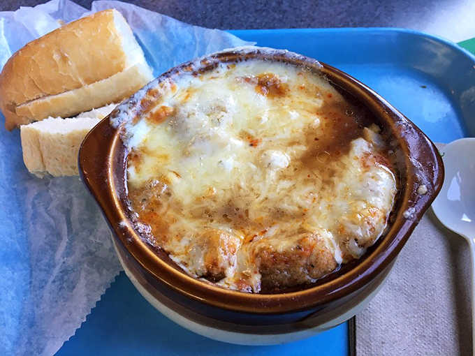 French onion soup arrives bubbling under a cheese blanket that stretches like the final frontier itself.