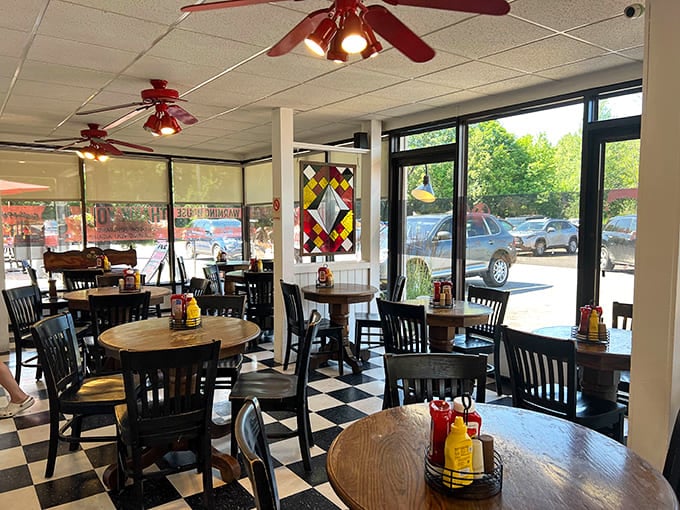 Bright windows and comfortable seating create a welcoming space where strangers become friends over exceptional comfort food.