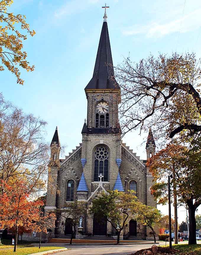 Guardian Angels Church's striking stone facade and blue-capped spire create a skyline silhouette that's unmistakably Manistee.