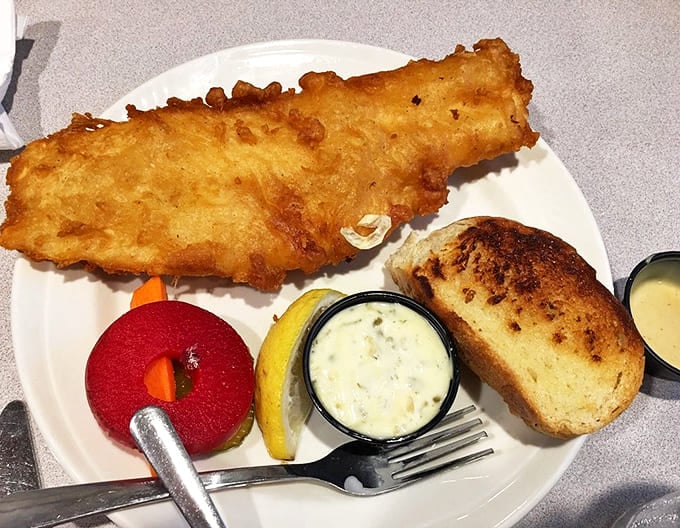 Fish so perfectly fried it practically shatters at the touch of a fork &ndash; golden, crisp, and served with all the classic accompaniments.