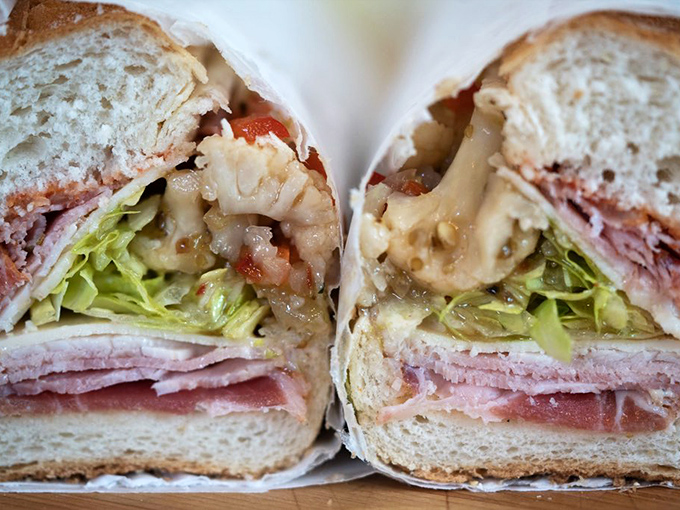 Half Cut: The architectural cross-section reveals the sandwich's perfect construction—each ingredient playing its essential role in the flavor symphony.