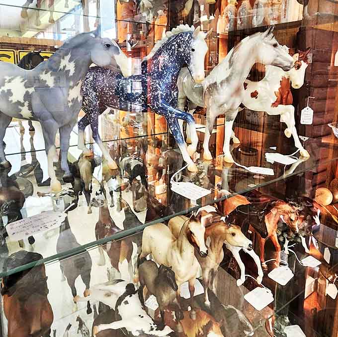 These painted ponies gallop eternally on glass shelves, appealing to equestrian enthusiasts and anyone who appreciates graceful animal sculptures.