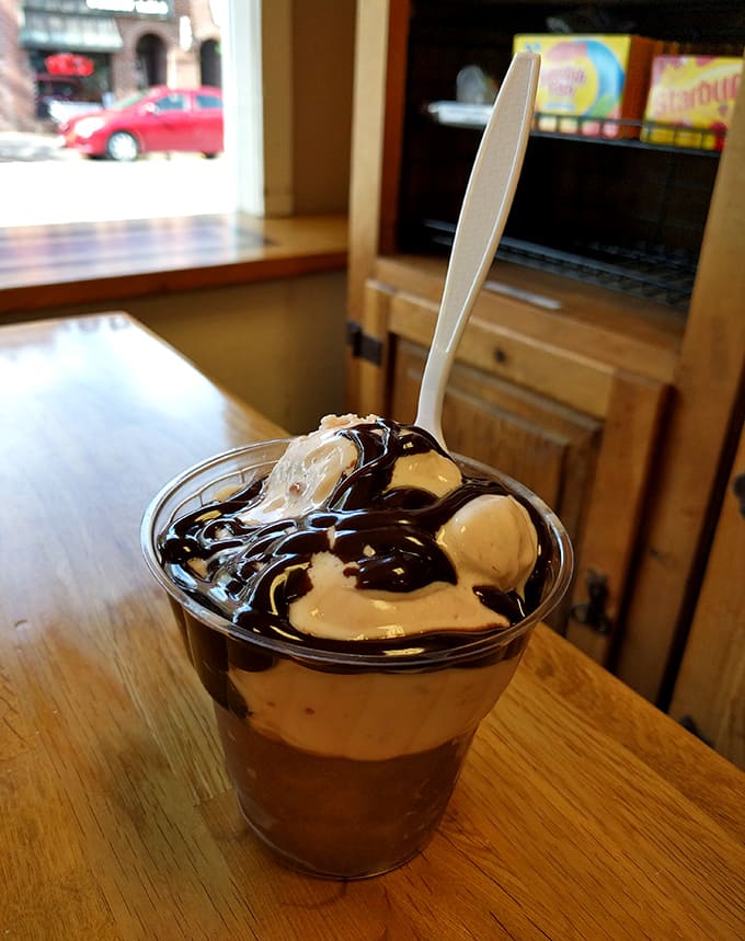 Hot fudge cascades over ice cream like a chocolate waterfall, creating a sundae worthy of its own Instagram account.