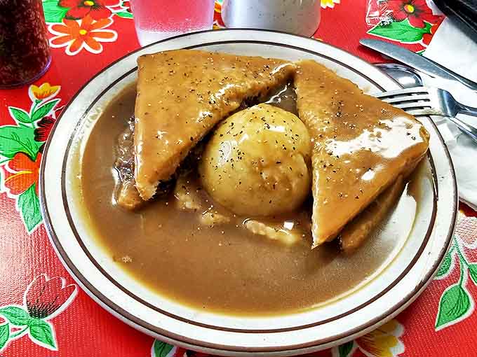 Hot roast beef sandwich &ndash; where gravy isn't just a condiment, it's a warm, savory blanket tucking in your lunch with love.