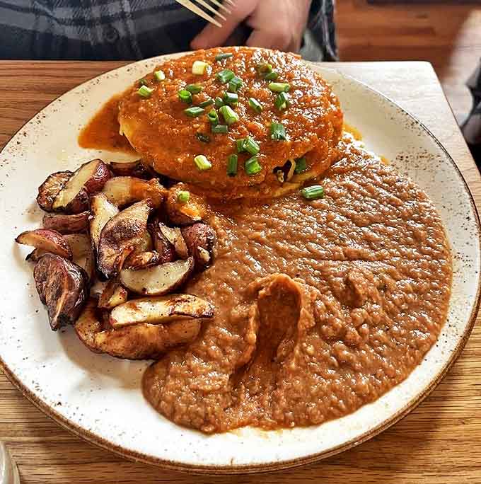 Huevos Rancheros: where breakfast meets art. Those roasted potatoes are the unsung heroes, quietly stealing the show while the sauce takes a bow.