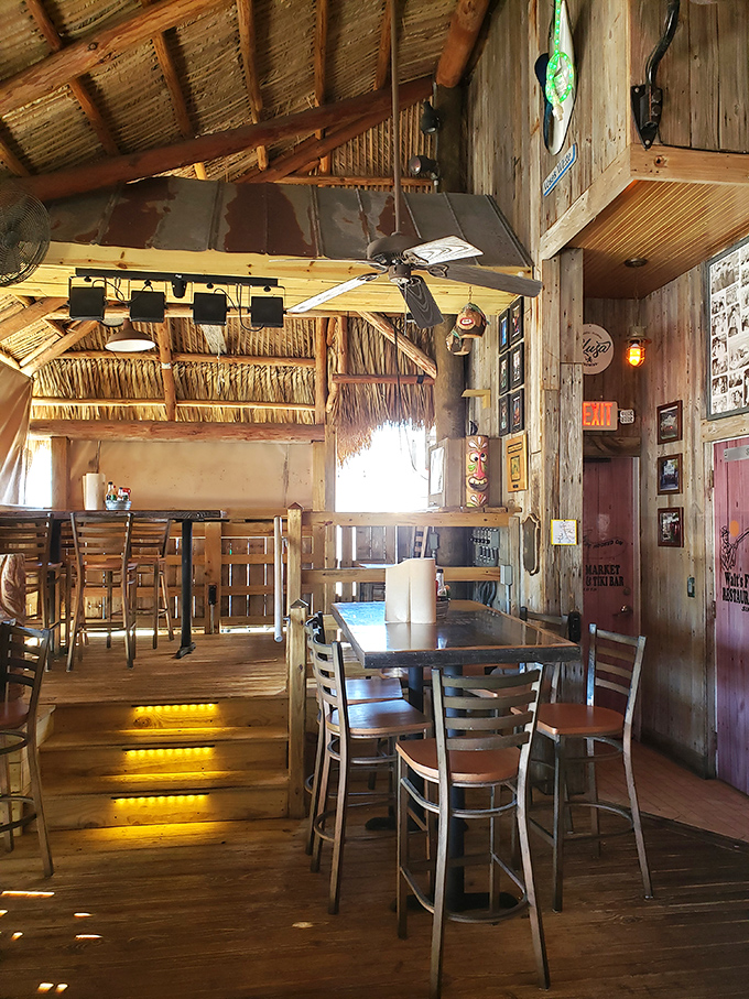 Interior Other Angle: Multi-level dining areas under rustic thatched ceilings create the perfect backdrop for seafood stories that get better with each retelling.