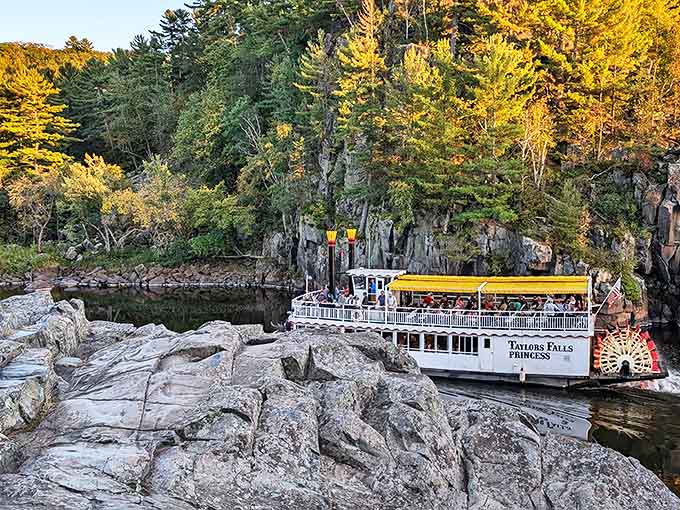 The Taylors Falls Princess navigates dramatic rock formations at Interstate State Park, where geology becomes theater and passengers get front-row seats.