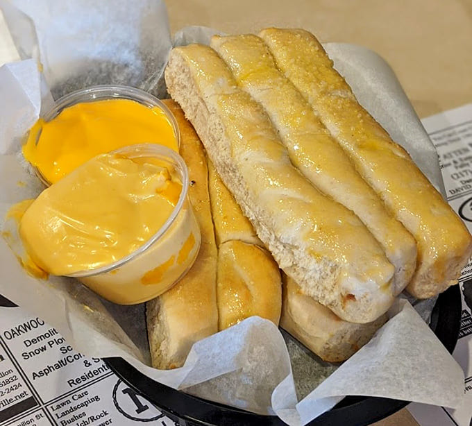 Golden breadsticks with cheese sauce for dipping are basically edible happiness sticks that disappear way too quickly.