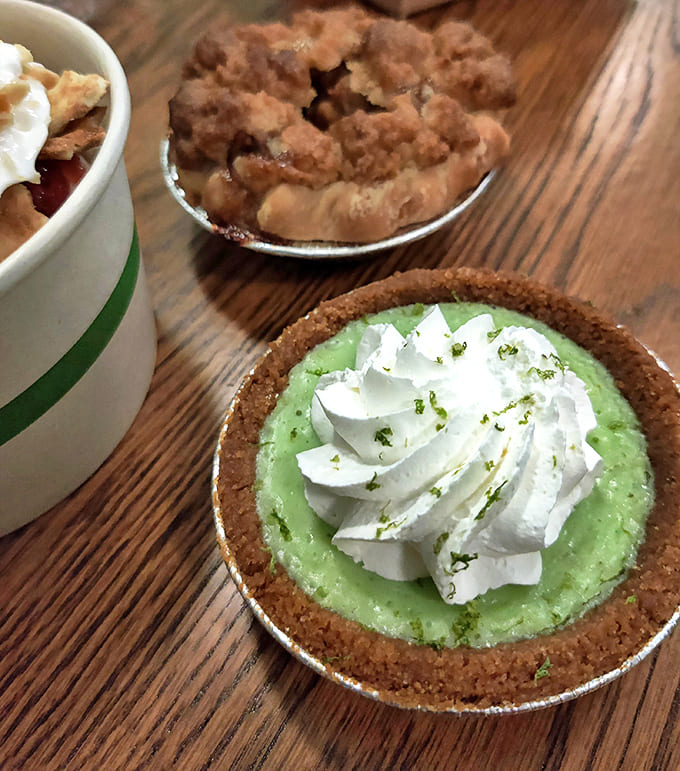 Key Lime Pie: This slice of heaven features a perfect balance of sweet and tart, topped with a dollop of cream that's begging to meet a glass of dessert wine.