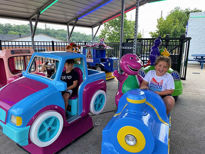 Colorful kiddie rides transport young visitors to a simpler time of mechanical joy, no screens or apps required.