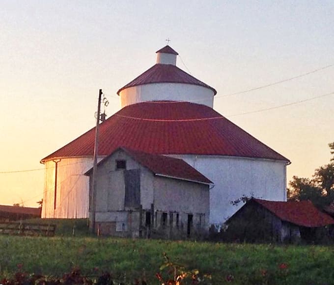 The round barn's distinctive silhouette stands as a testament to agricultural ingenuity, its circular design eliminating corners where hay could get stuck.