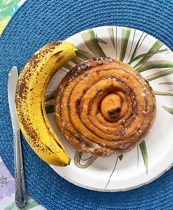 Size comparison between nature's perfect fruit and The Looney Baker's perfect cinnamon roll – both nutritious in completely different ways.