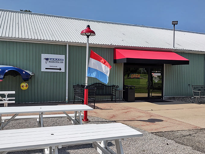 The exterior welcomes visitors with picnic tables and classic car vibes, making it clear this isn't your typical roadside attraction.