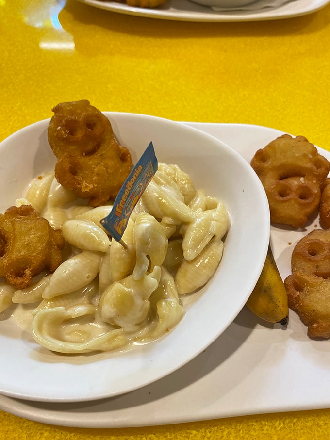 Mac and cheese gets the Minion treatment with character-shaped potato tots standing guard over creamy pasta &ndash; comfort food with googly eyes.