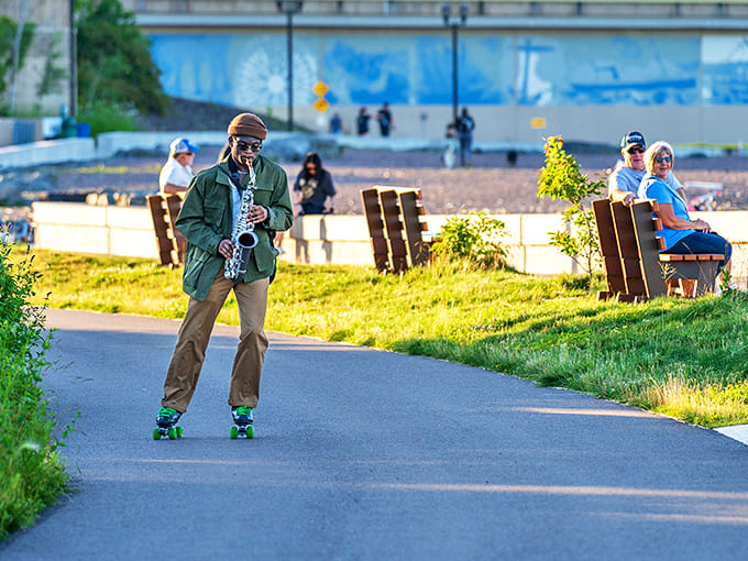 A saxophonist adds a smooth jazz soundtrack to the lakeside scene, his melodies floating across the water like musical messages in bottles.