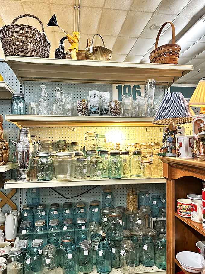 Blue-tinted Mason jars catch the light like aquatic treasures &ndash; each one potentially the perfect vessel for grandma's secret pickle recipe.