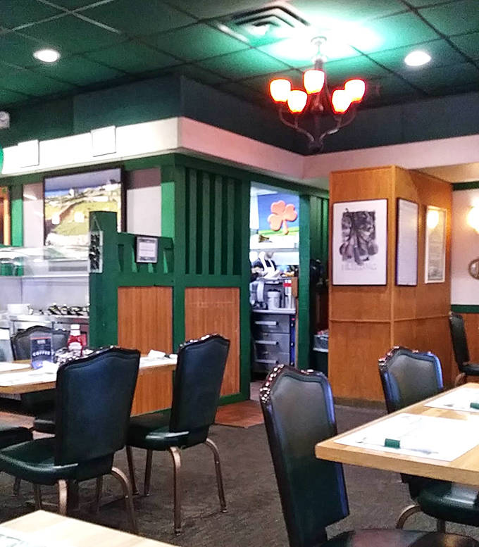 Green accents and stained glass dividers section the dining room into intimate spaces where families have celebrated special occasions for generations.