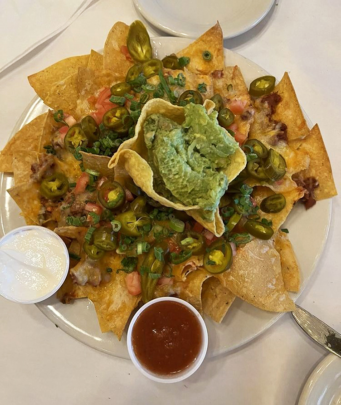 These aren't your average nachos &ndash; they're a mountain of crispy chips, melted cheese, and jalape&ntilde;os with guacamole playing conductor.