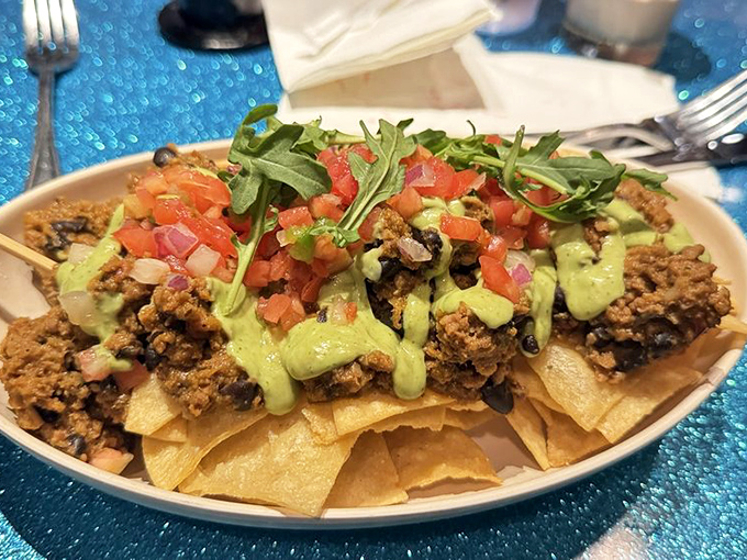 The Sci-Fi Impossible Nachos pile high with all the fixings, proving that even plant-based eating can involve gloriously excessive amounts of toppings.
