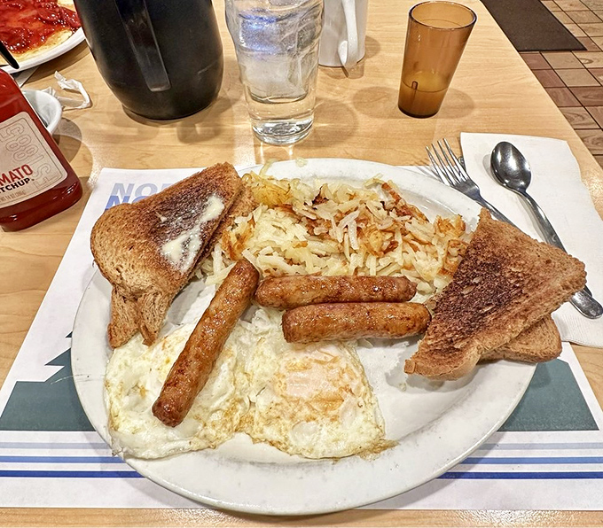 The breakfast of champions: eggs, sausage, hash browns, and toast arranged in perfect harmony like a morning symphony on china. 