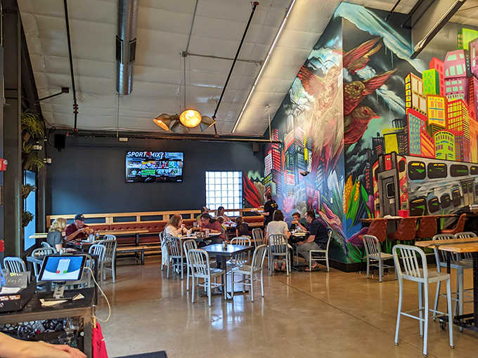 Conversations flow as freely as the beer in this vibrant space where colorful murals transform industrial walls into urban canvases.