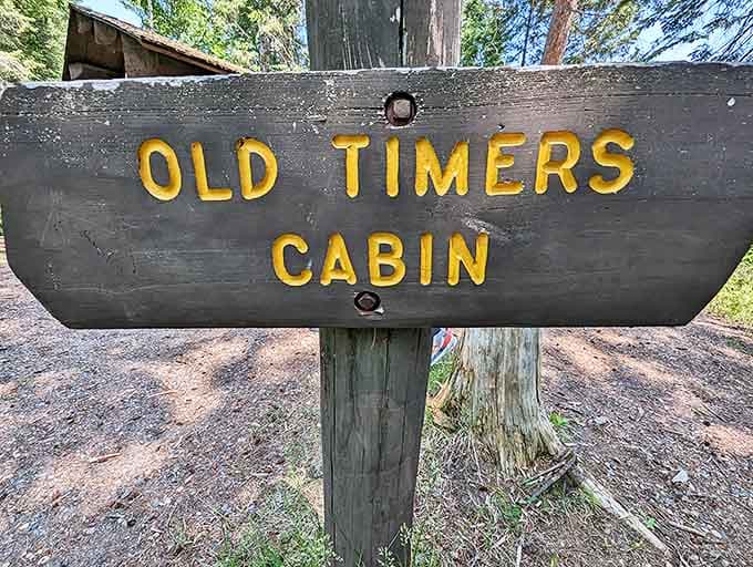 "Old Timers Cabin" &ndash; the hand-carved sign points the way to history, its weathered wood a testament to endurance.