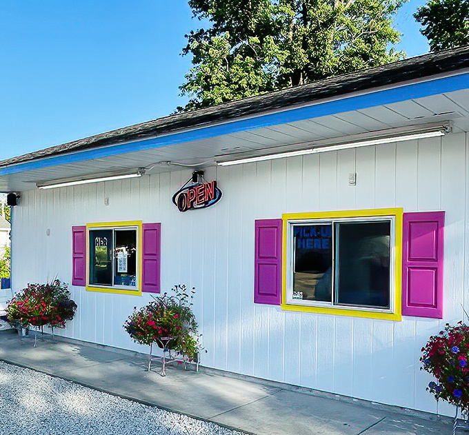 Order Window: Cheerful pink shutters frame the gateway to happiness &ndash; where summer dreams are served one cone at a time.