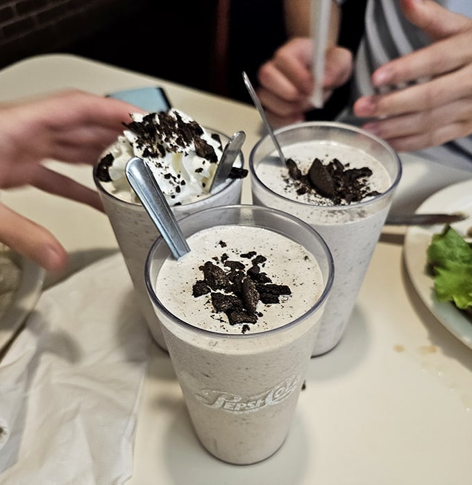 These aren't just milkshakes; they're desserts with straws, topped with whipped cream and cookie crumbles.