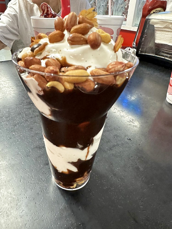 The peanut cluster parfait defies gravity and good sense, layering chocolate, vanilla, and crunchy nuts into a tower of sweet indulgence.